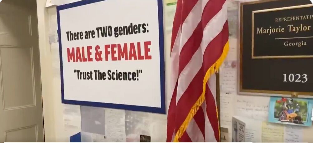 Marjorie Taylor Greene shows off the anti-trans sign hanging in her ...