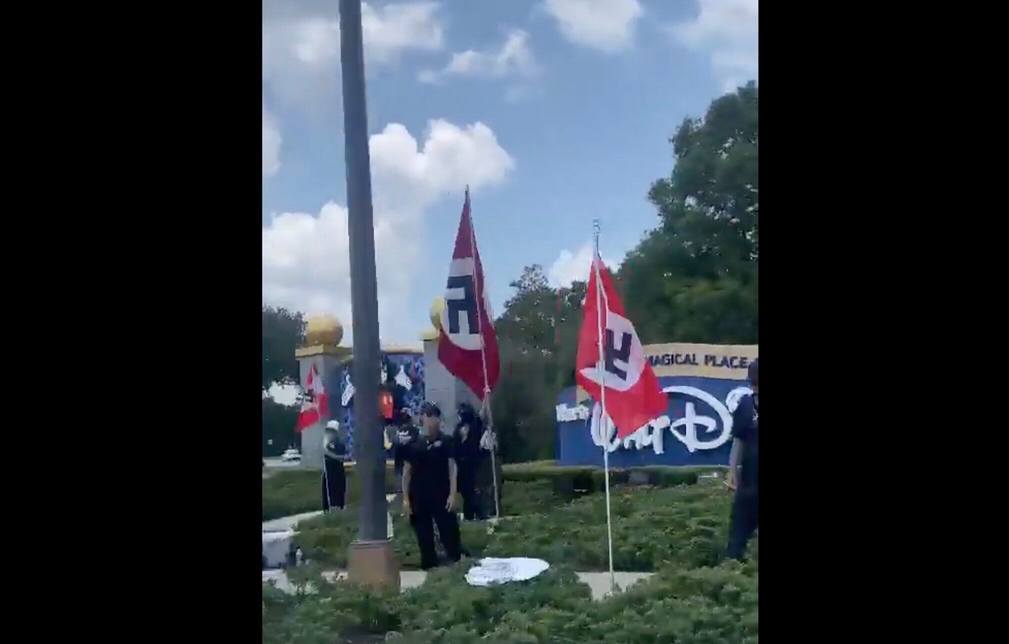 Nazi protestors wave swastika & Ron DeSantis flags outside Disney World ...